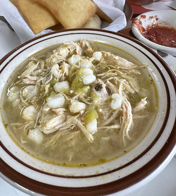 The green chile posole – a bowl of shredded chicken, hominy, and chile that's like a warm hug from your abuela, even if you never had one.