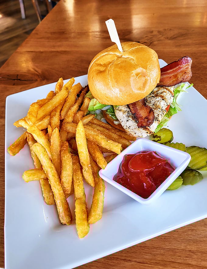 This isn't just lunch; it's edible architecture&mdash;a towering chicken sandwich flanked by golden fries and house-made pickles.
