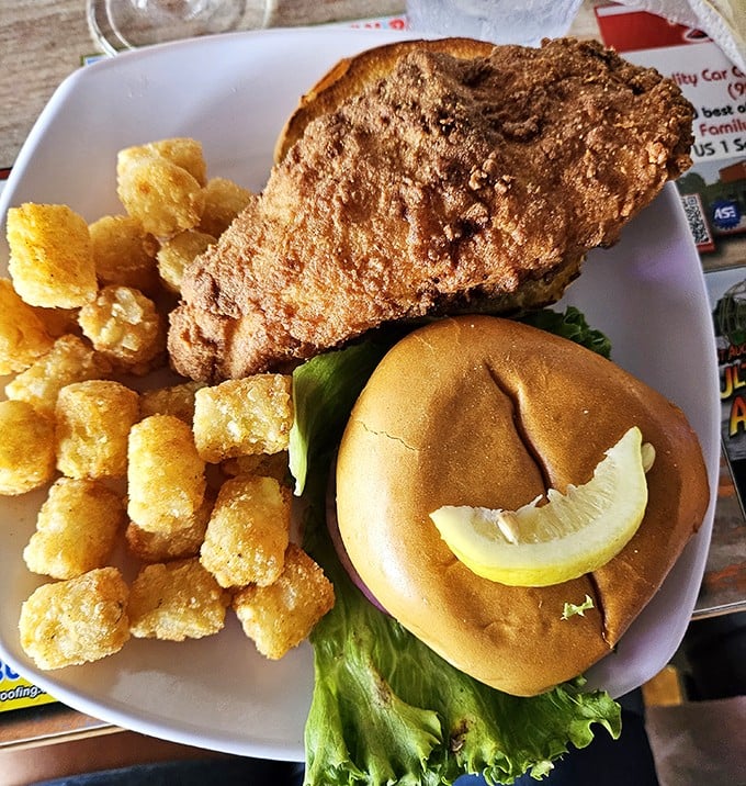 The golden-fried grouper sandwich: proof that sometimes the best things in life come between two pieces of bread with a side of tater tots.
