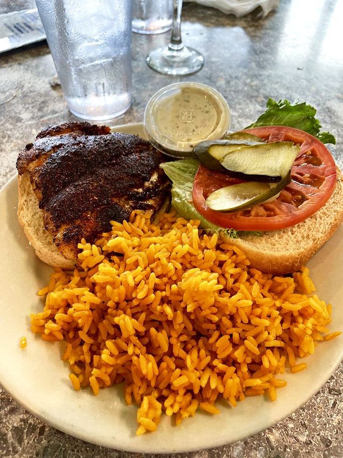 The blackened grouper sandwich: where fish so fresh it practically introduces itself meets rice that's been taking notes from Southern grandmothers for generations.
