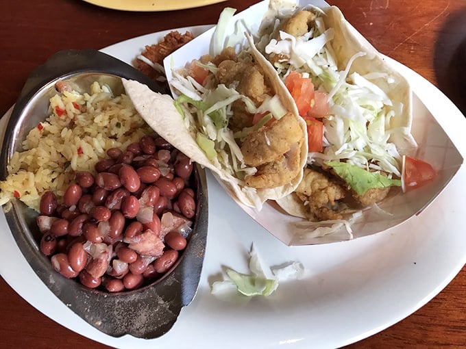 Island-inspired tacos arrive with colorful companions &ndash; red beans and seasoned rice that transport you straight to coastal paradise.