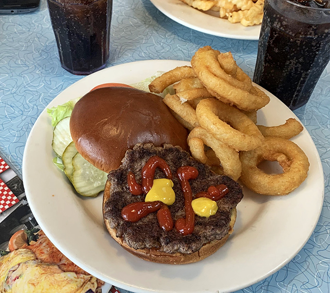 This burger doesn't need fancy aioli or artisanal buns to make its point. Just honest beef, classic toppings, and those glorious onion rings that deserve their own fan club.