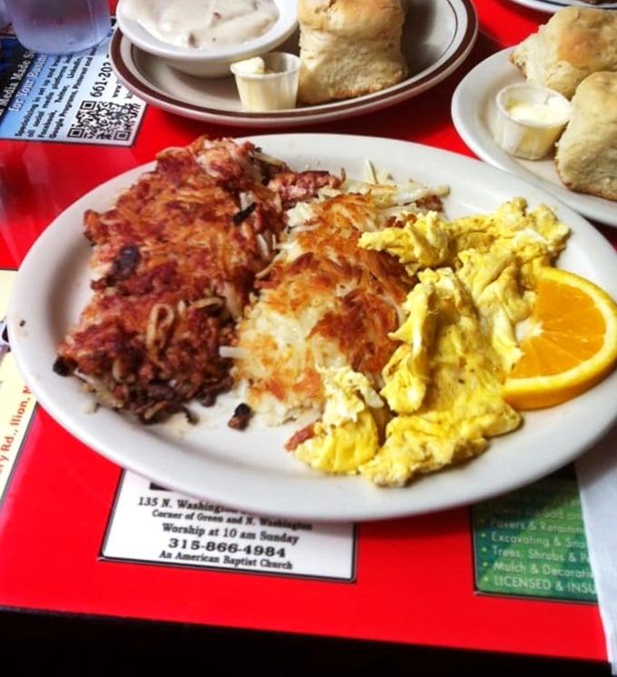 The holy trinity of breakfast perfection: golden hash browns, fluffy scrambled eggs, and corned beef hash that would make your grandmother weep with joy.