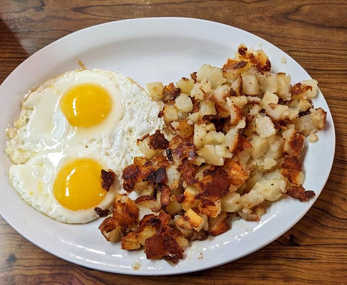 Two sunny-side up eggs with a mountain of crispy hash browns&mdash;the breakfast equivalent of a perfect high-five.