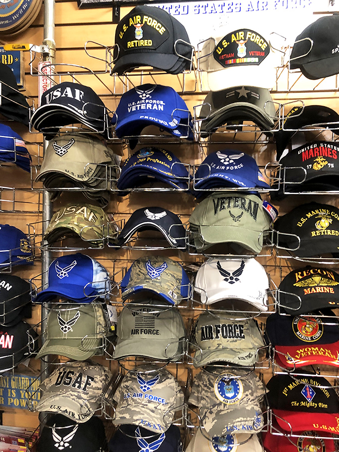 Military pride on display—each cap tells a story of service, sacrifice, and that unmistakable hat-hair everyone pretends not to notice.