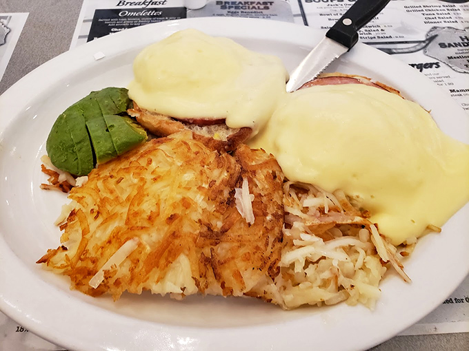 Eggs Benedict with crispy hash browns that achieve the impossible: that perfect balance between golden exterior crunch and tender interior that lesser establishments only dream about.