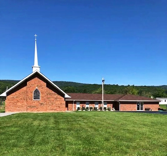 Highland Baptist Church stands sentinel against the mountains, its brick fa&ccedil;ade warmed by generations of Sunday gatherings.