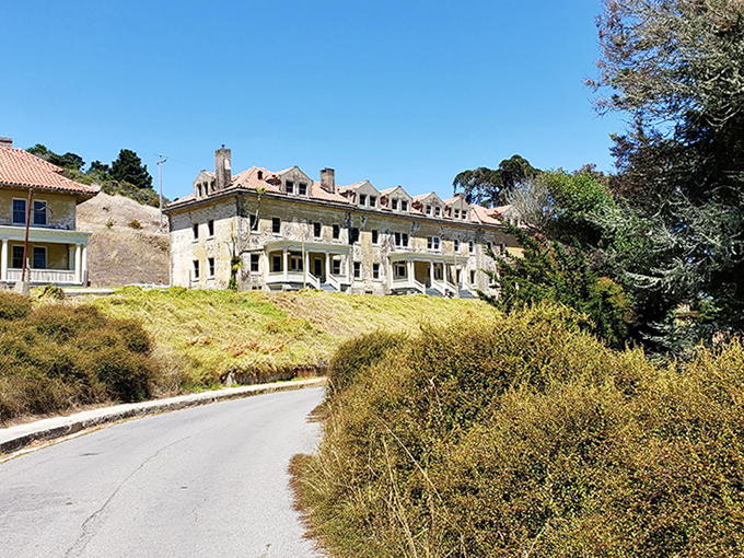 These weathered barracks whisper stories of the past while standing proudly against the golden California hillside, like sentinels guarding forgotten memories.