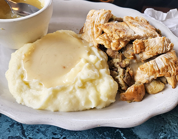 Mashed potatoes so fluffy they practically levitate off the plate, accompanied by chicken that's tender beyond all reason.