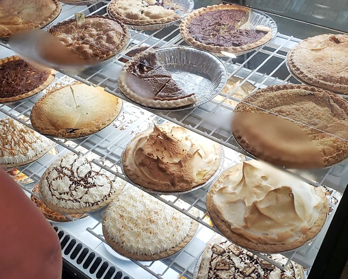 The pie case at Olde Country Diner is basically a museum of American dessert artistry. Each perfectly crimped crust holds treasures that would make grandmothers nod in approval.