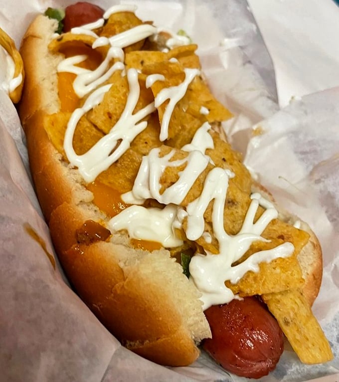 The "El Santo" hot dog comes dressed to impress with Fritos, cheese, and enough toppings to make you question whether utensils might be necessary after all.