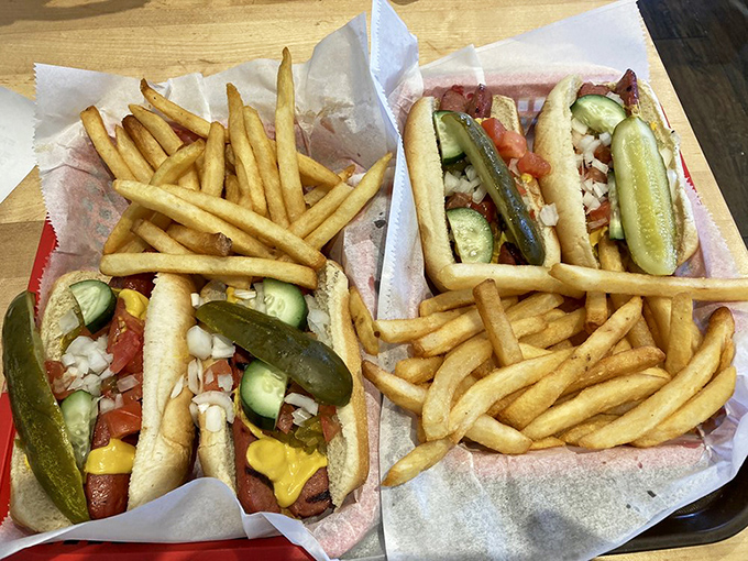 Chicago-style hot dogs dressed to impress with that garden of toppings. The pickle spear standing at attention like it's guarding something precious&mdash;which it is.