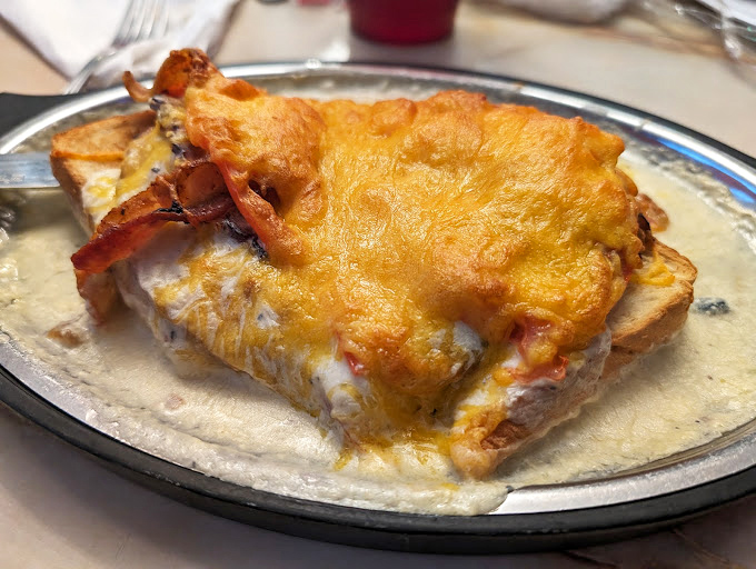 The legendary Hot Brown &ndash; an open-faced masterpiece where cheese sauce meets toast in a relationship worth writing home about.