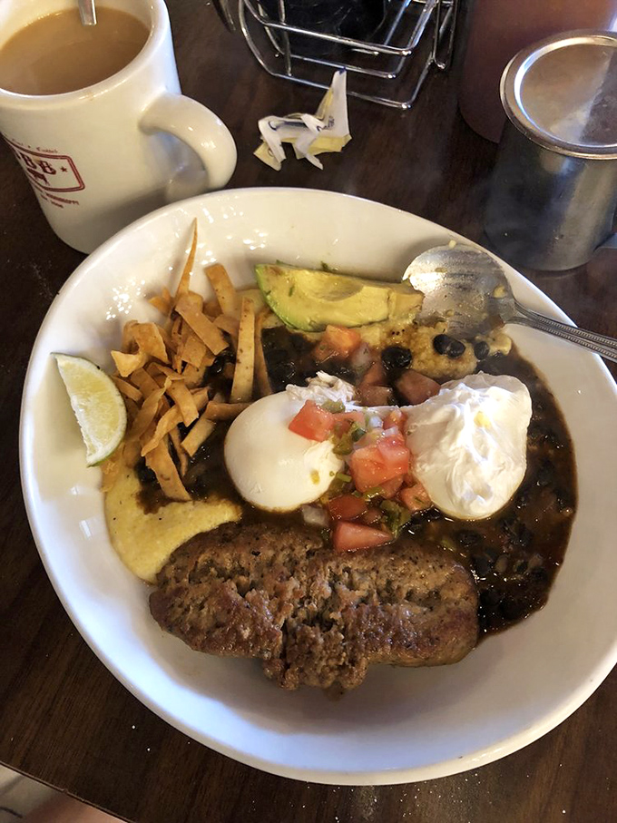 Huevos Rancheros that crosses borders and breaks rules&mdash;poached eggs floating on black beans with avocado and tortilla strips creating the breakfast equivalent of a standing ovation.