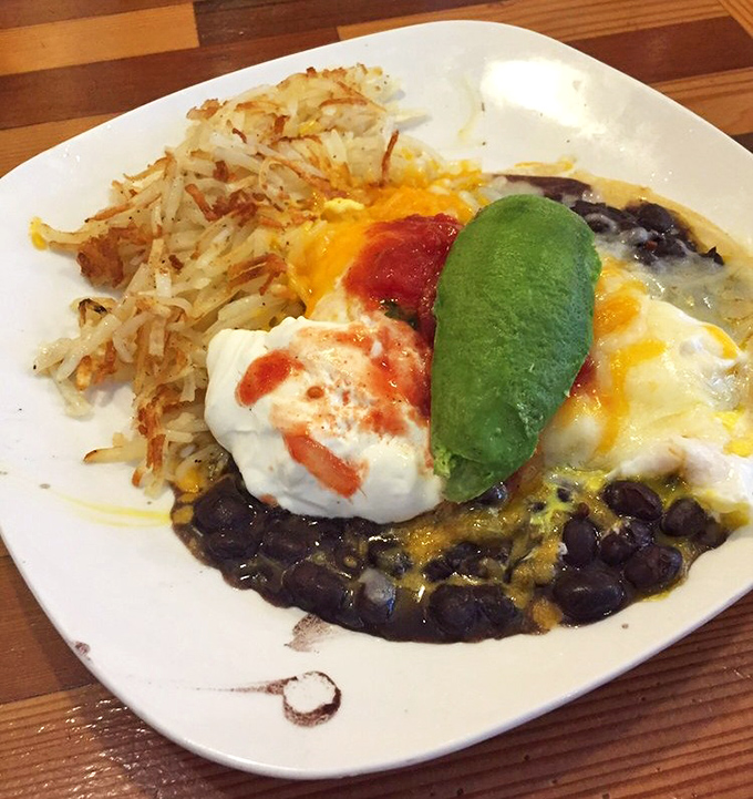 The Huevos Rancheros arrive like edible art&mdash;a canvas of black beans topped with melted cheese, eggs, sour cream, salsa, and that perfect slice of avocado.