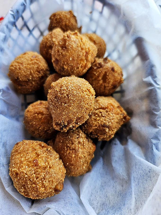 These golden-brown hush puppies aren't just side dishes—they're little orbs of cornmeal joy, perfect for sopping up every last bit of crab juice.