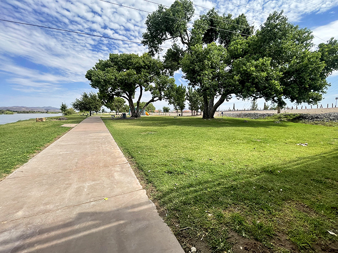La Llorona Park provides a green oasis along the Rio Grande, where shade trees and walking paths offer respite from the desert heat.
