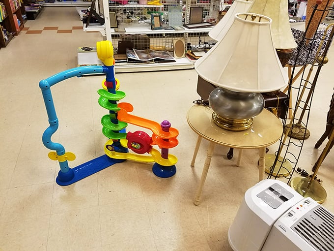 The juxtaposition says it all: yesterday's elegant lamp stands proudly beside today's colorful children's toy, both waiting for their next chapter.