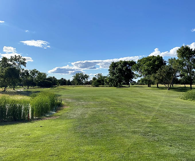 Lee Park Golf Course stretches toward the horizon, where South Dakota's endless sky becomes part of the game.