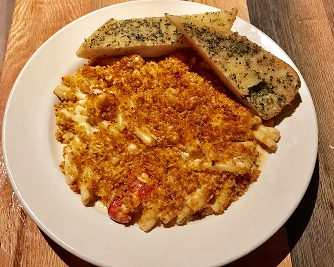 Lobster mac and cheese that would make a New Englander weep with joy – golden, crispy, and utterly indulgent.
