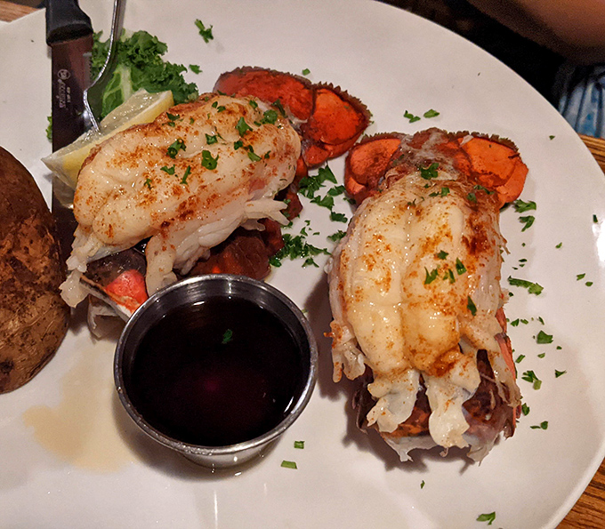 Twin lobster tails that could make a mermaid jealous. The perfectly clarified butter is basically liquid gold for seafood royalty.