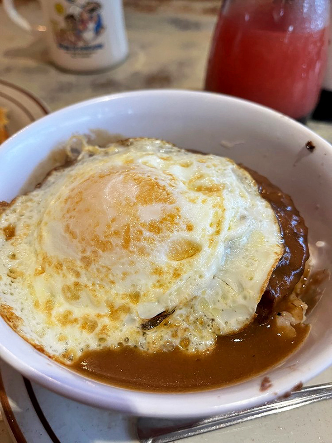 The holy grail of Hawaiian comfort food&mdash;the iconic loco moco &ndash; with a perfectly fried egg crowning a hamburger patty, all swimming in gravy that deserves its own fan club.