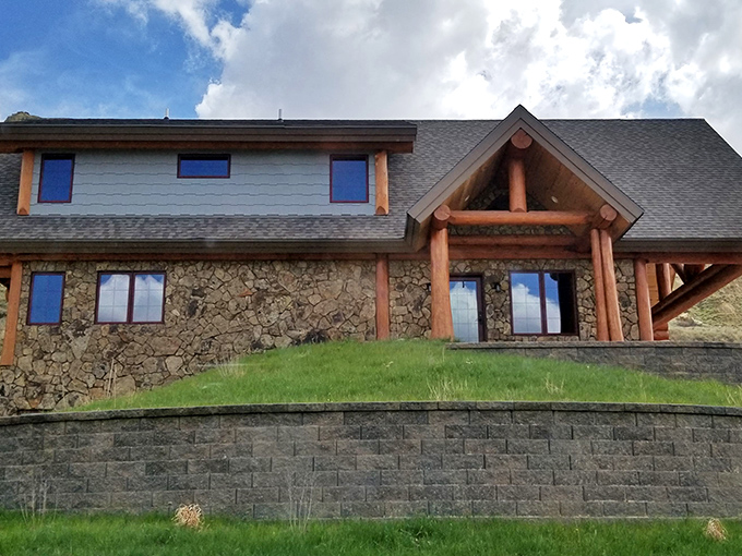This rustic stone-and-timber lodge blends seamlessly into the landscape, like Mother Nature herself designed a cozy retreat for weary hikers.