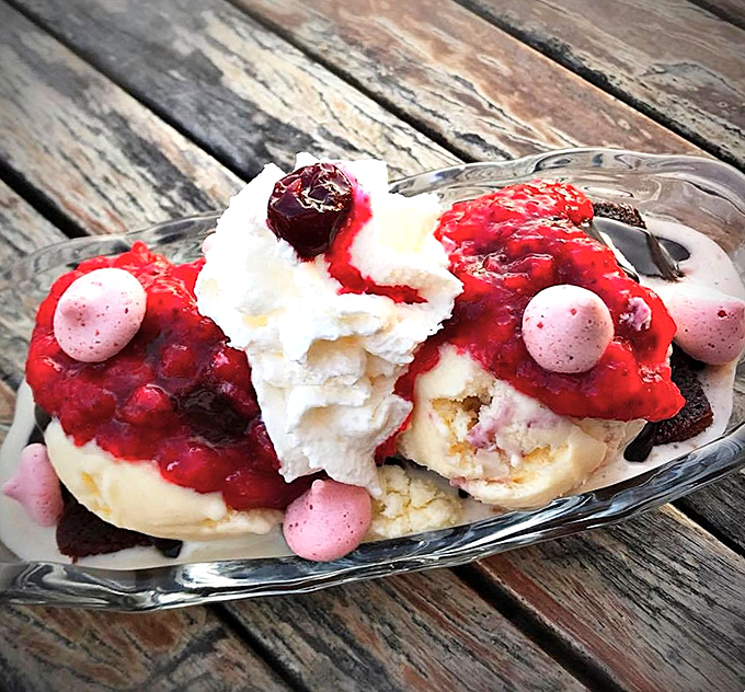 This berry-laden sundae isn't just dessert—it's edible architecture. The whipped cream clouds support a berry skyline that demands exploration.