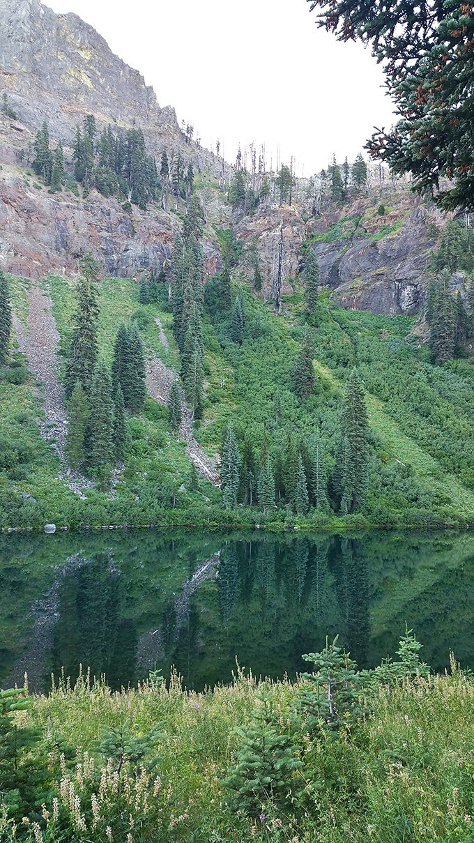 The Marble Mountain Wilderness mirrors itself in crystal waters, nature's version of a selfie that actually deserves to be shared.