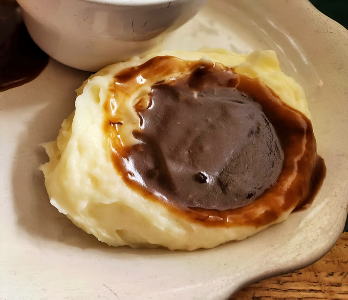 Cloud-like mashed potatoes cradle a pool of rich brown gravy &ndash; the perfect dance partner for Katie's legendary meatloaf.