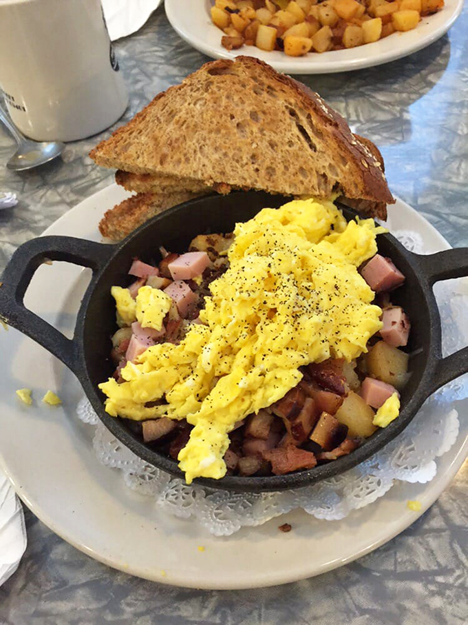 The All Meat Skillet &ndash; where bacon, ham, and potatoes unite under a blanket of scrambled eggs. Carnivore poetry in cast iron form.