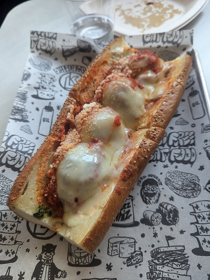 This meatball parm isn't just a sandwich; it's a saucy love letter to Italian-American cuisine on custom-printed paper.