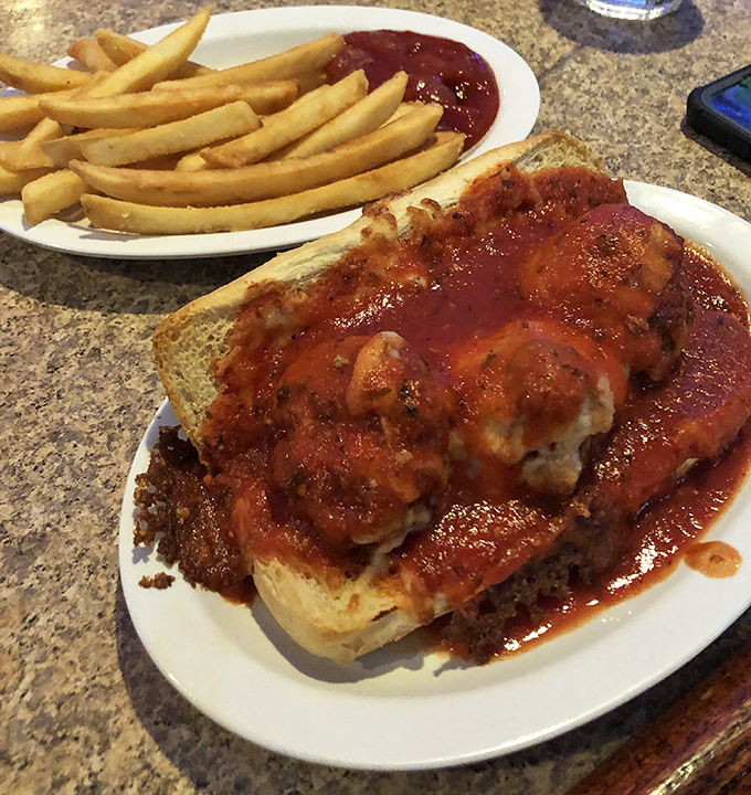 The open-faced meatball sandwich doesn't believe in restraint. That sauce-to-bread ratio tells you everything about their priorities.