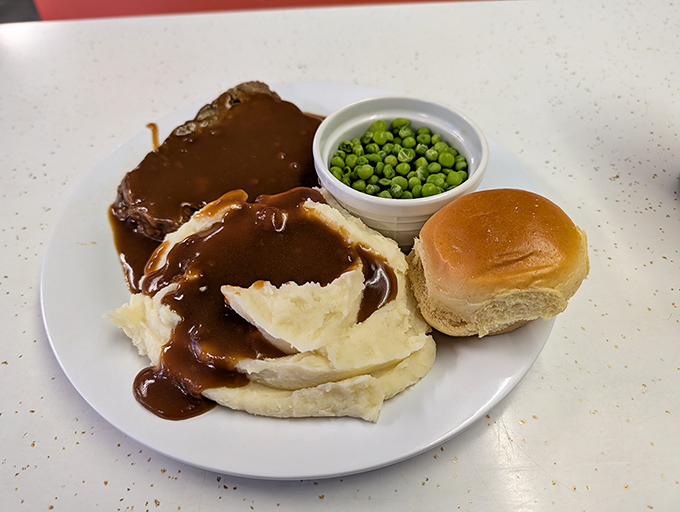 Meatloaf that would make your grandmother jealous, swimming in rich gravy alongside mashed potatoes that clearly never came from a box. Pure comfort on a plate.