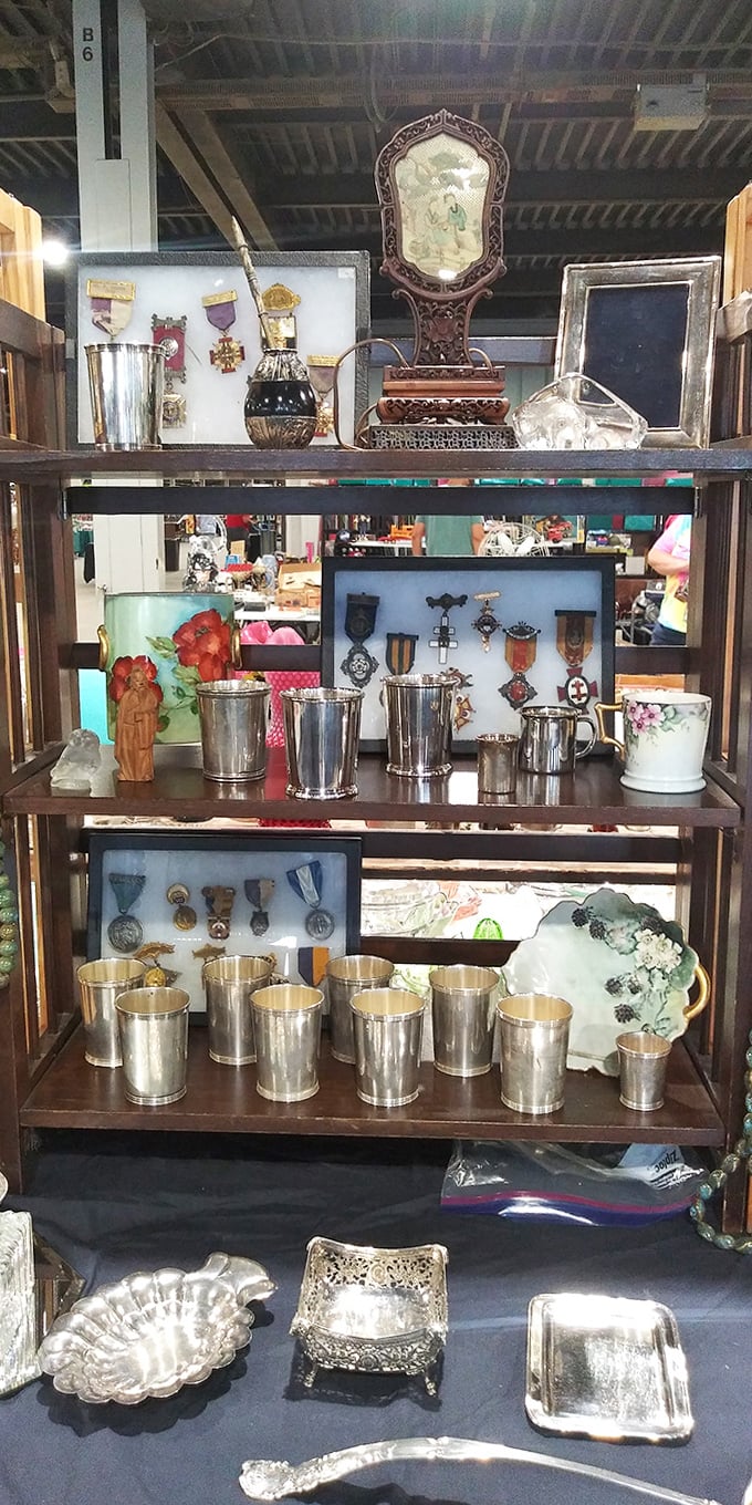 Military medals and sterling treasures share space in this cabinet of curiosities. Each piece whispers tales of formal dinners and decorated heroes.