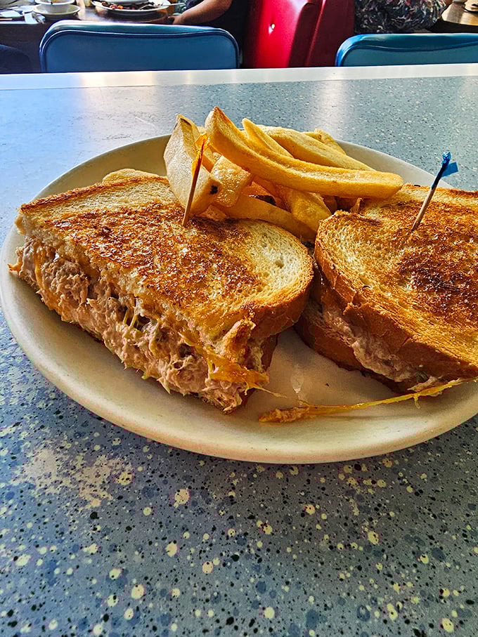 A tuna melt so generously stuffed it requires architectural planning to eat without losing half the filling on your plate.