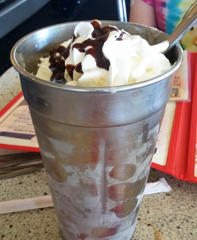 This isn't just a milkshake &ndash; it's a frosty metal cup of happiness topped with whipped cream and chocolate sauce that demands to be savored, not rushed.