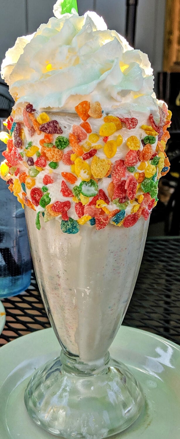 That milkshake looks like a carnival decided to throw a party in a glass, and honestly, nobody's complaining about it. 