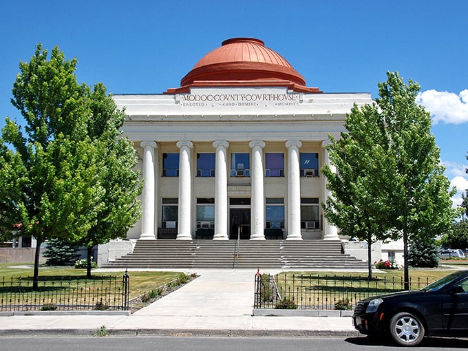 The Modoc County Courthouse stands proudly with its classical columns and copper dome&mdash;government architecture with actual personality.