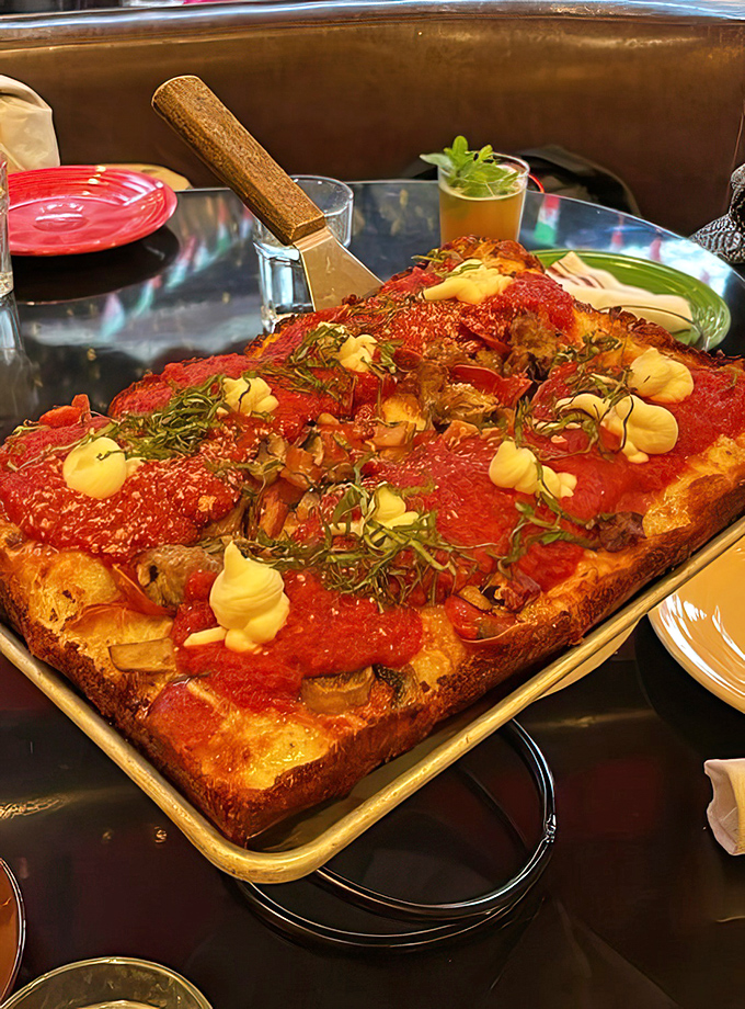 Detroit-style pizza done right: thick, airy crust crowned with vibrant sauce and those coveted caramelized cheese edges that make you weak in the knees.