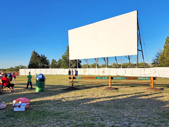 The morning sun reveals the impressive scale of the screen, standing ready for another evening of entertainment against the endless Kansas blue.
