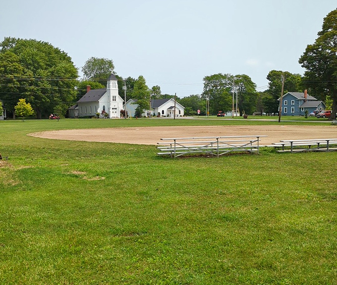 The community baseball diamond and white steeple church create a Norman Rockwell scene that screams "Americana" louder than apple pie.