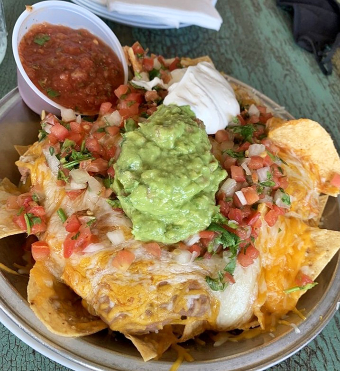 Nachos that require a strategy session before eating—where to start when every chip is a treasure map of cheese, guacamole, and pico de gallo?