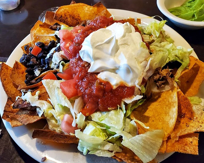 Nachos that require a strategic eating plan. Each chip a delivery system for maximum toppings, with sour cream and salsa creating flavor zones worth exploring.