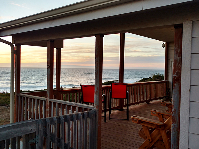 Sunset chasers, your office awaits. Two red chairs perfectly positioned for nature's nightly spectacle&mdash;no tickets required, applause encouraged.