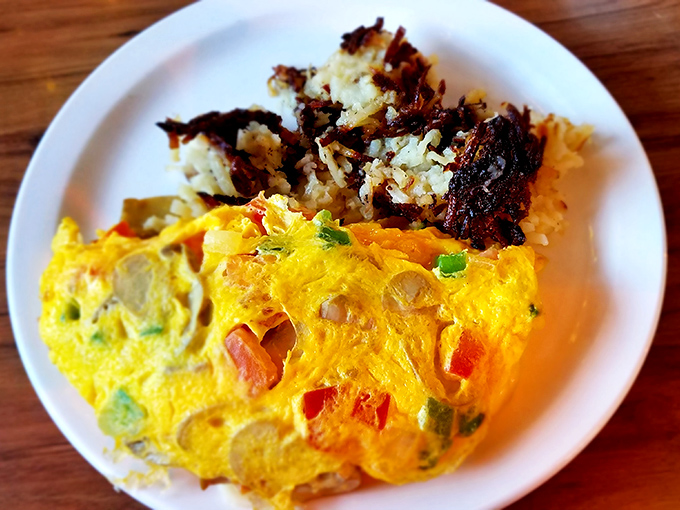 This isn't just breakfast; it's morning therapy. The omelet practically glows with promise, while those hash browns have achieved the perfect crisp-to-tender ratio.