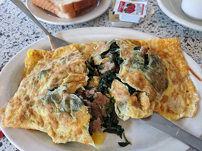 This isn't just an omelet&mdash;it's a fluffy golden envelope delivering a love letter of spinach and sausage. The kind of breakfast that makes you cancel lunch plans.