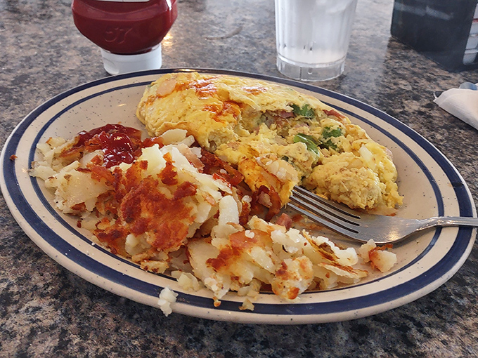 Breakfast perfection on a plate—fluffy omelet meets crispy home fries in a morning romance that puts most dating apps to shame.
