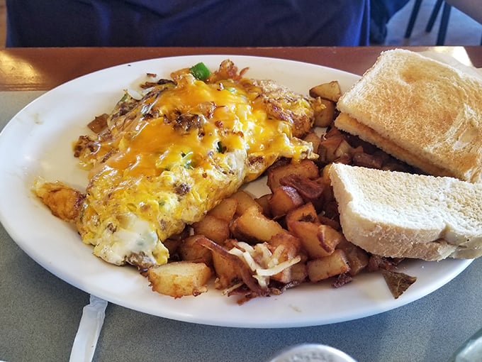 This omelet doesn't just sit on the plate&mdash;it commands attention with melted cheese cascading down its sides like a yellow waterfall of deliciousness.
