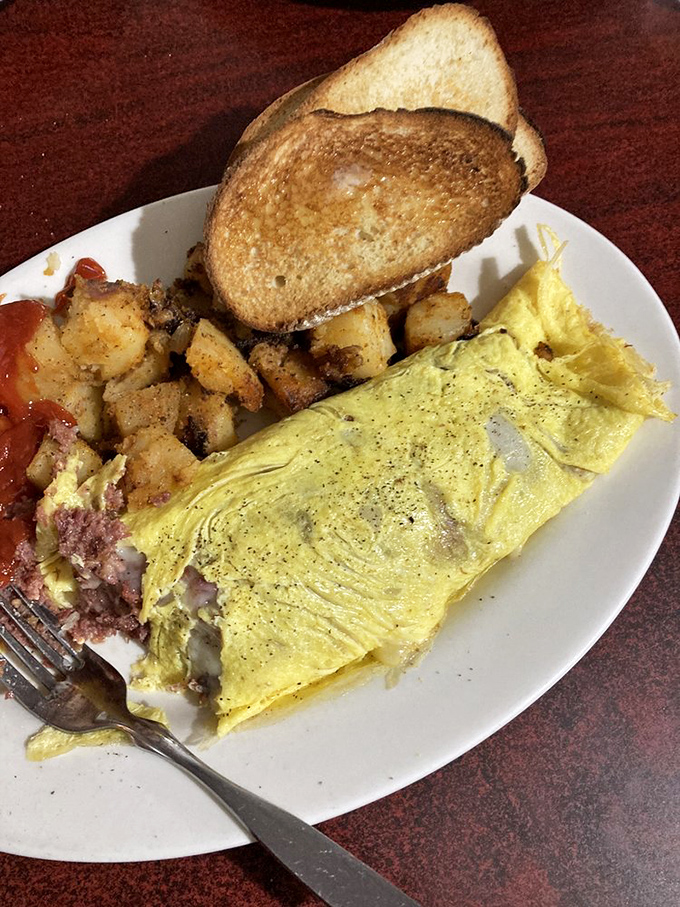 This isn't just an omelet—it's a morning masterpiece with perfectly folded eggs embracing their fillings like a warm hug from your favorite aunt.